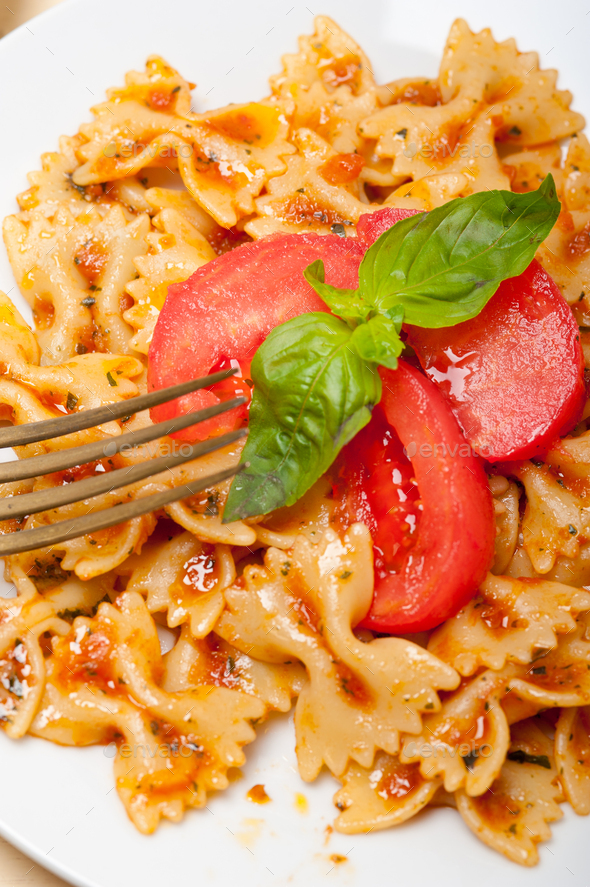 Italian pasta farfalle butterfly bow-tie and tomato sauce Stock Photo by keko64